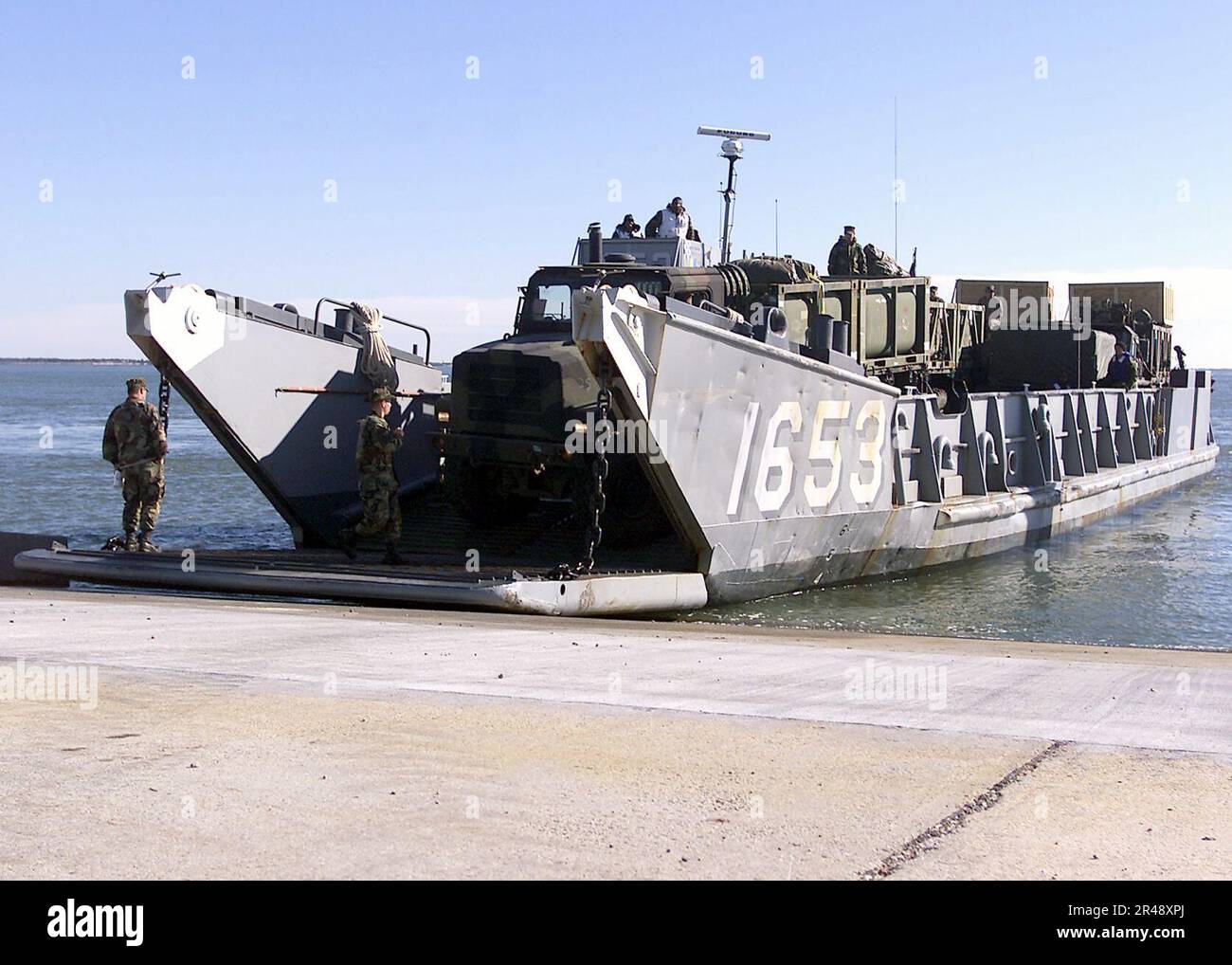US Navy U.S. Marines assigned to Camp Lejeune, N.C., load heavy trucks ...