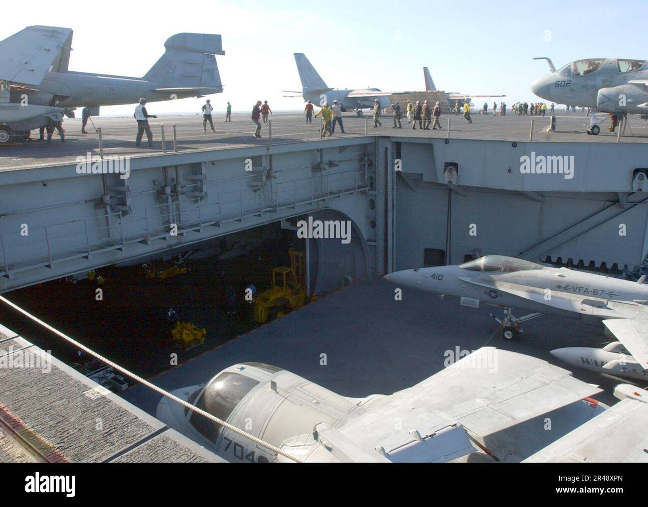 US Navy Two aircraft are transferred from the ship's hangar bay to the ...