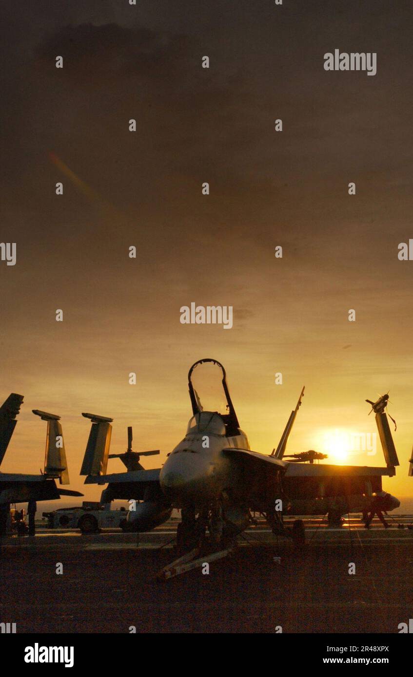 US Navy sun rises behind an F-A-18 Stock Photo - Alamy