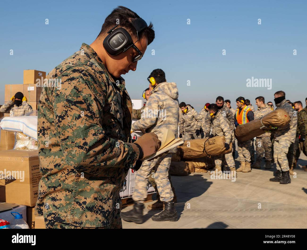 A U.S. Marine assigned to Task Force 61/2 (TF 61/2), takes note of all ...