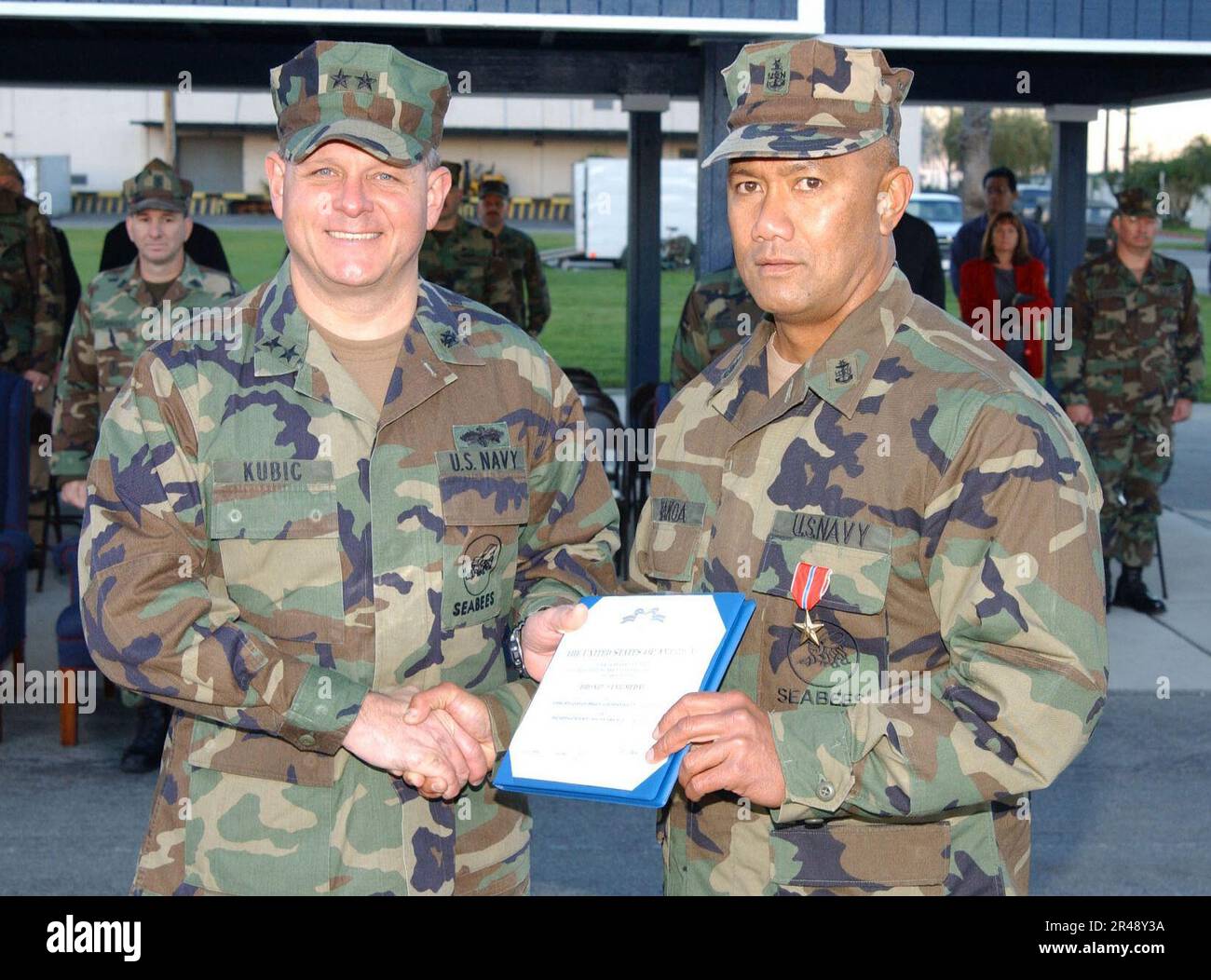 US Navy Rear Adm. Charles Kubic, presents the bronze star to Senior ...