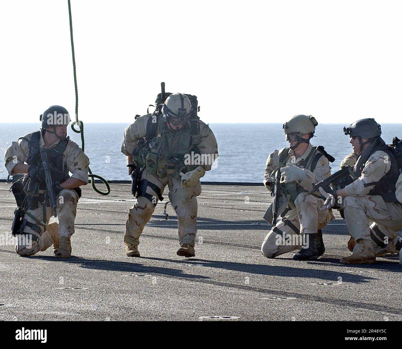 US Navy A U.S. Navy SEAL (SEa, Air, and Land) fast-ropes to the deck of ...