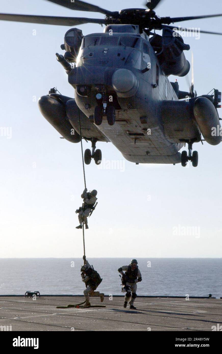 US Navy A U.S. Navy SEAL (SEa, Air, and Land) fast-ropes from an MH-53 ...