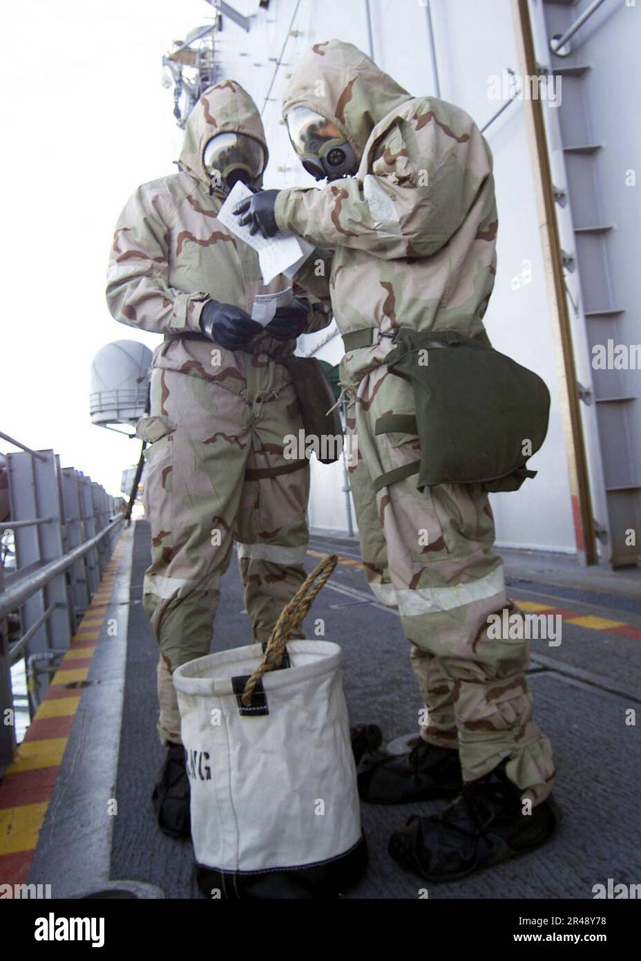 US Navy Ship's personnel go through chemical, biological, and ...