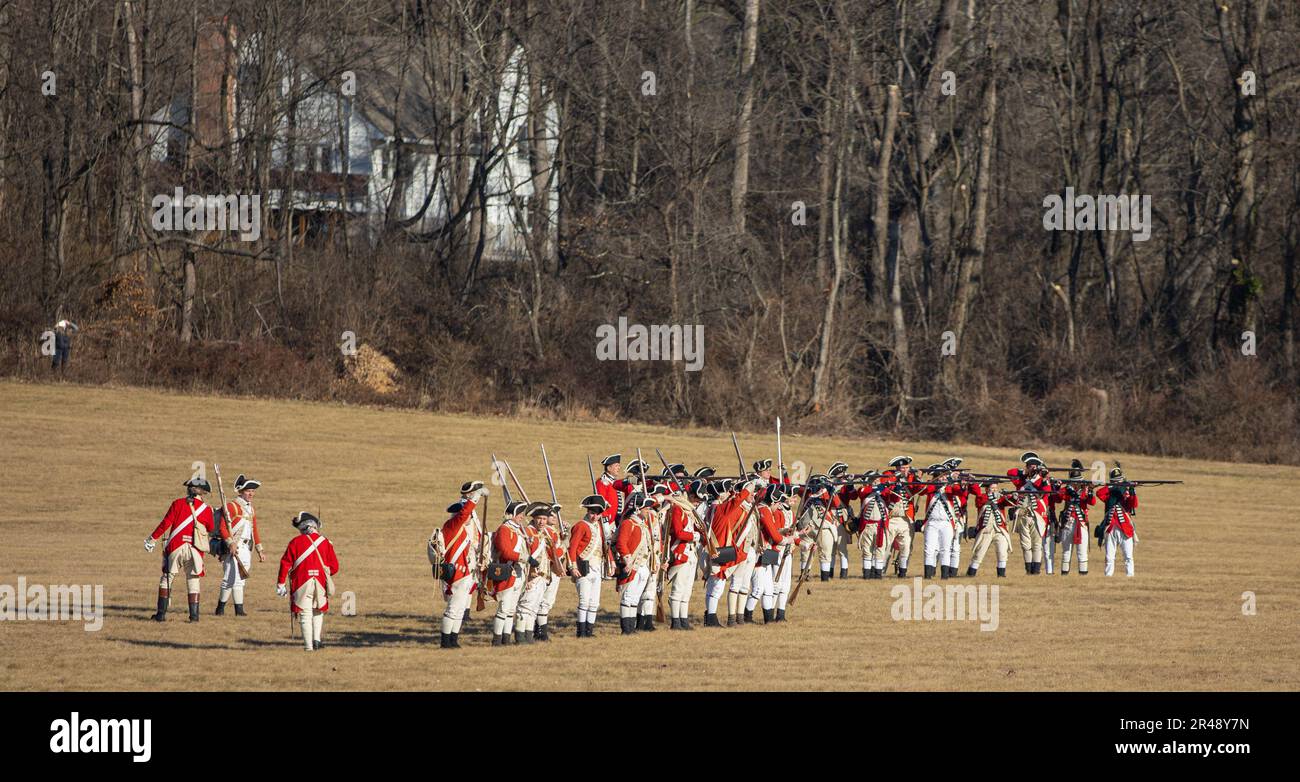 Local volunteers representing the British Army fire their rifles during ...