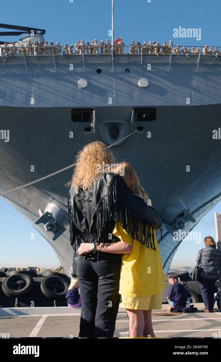 US Navy Wife and daughter hug as they bid farewell to their Sailor ...