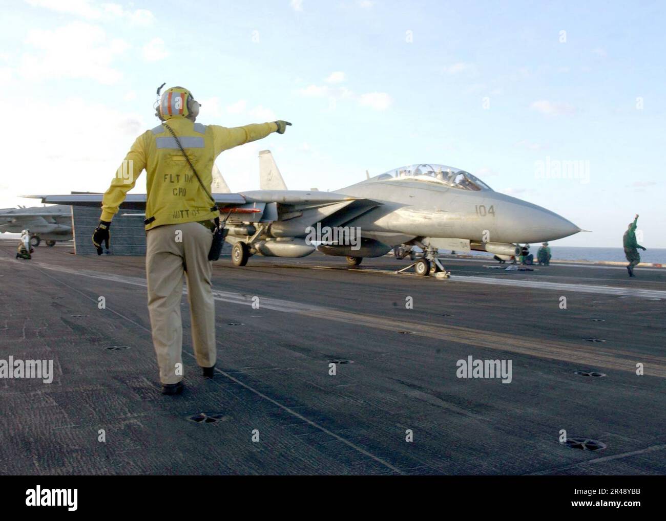 US Navy A plane director guides an F-14 into launch position on the ...