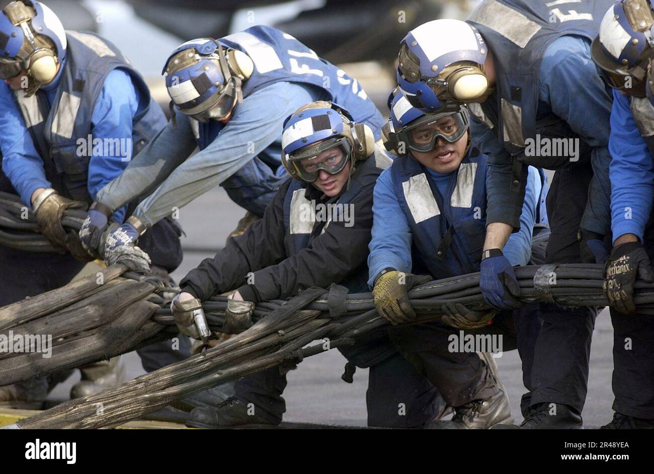 US Navy Flight deck crew members rig the emergency barricade net Stock ...