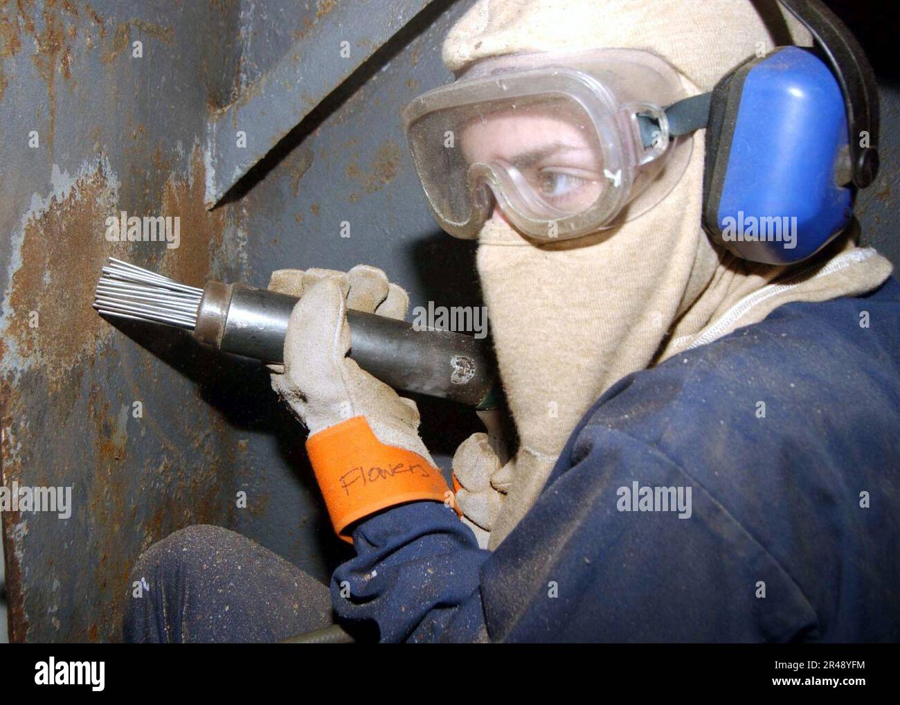US Navy using a needle gun to removes layers of paint Stock Photo - Alamy