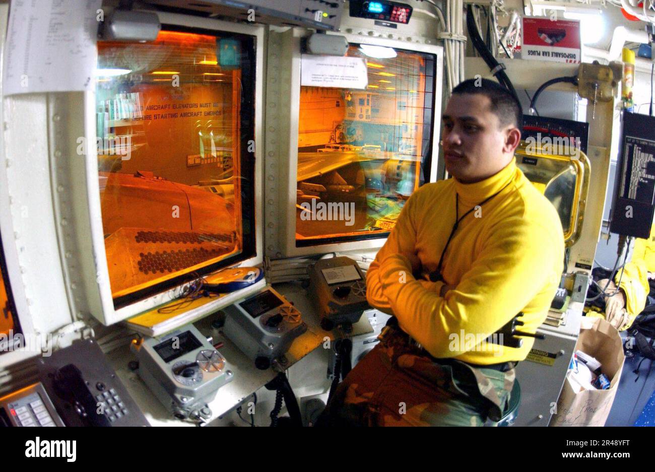 US Navy Sailor stands watch on a conflagration station overseeing the ...