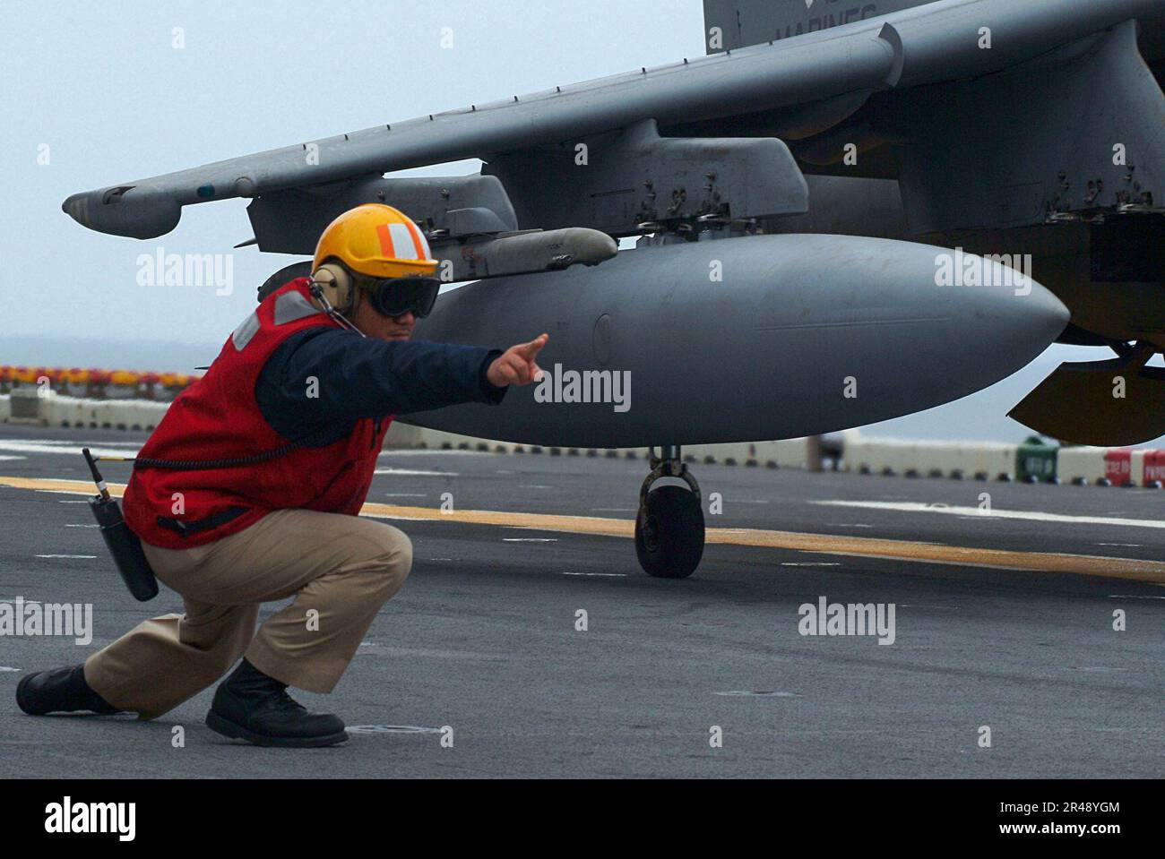 US Navy A Sailor aboard USS Essex (LHD 2) gives an AV-8B Harrier the ...