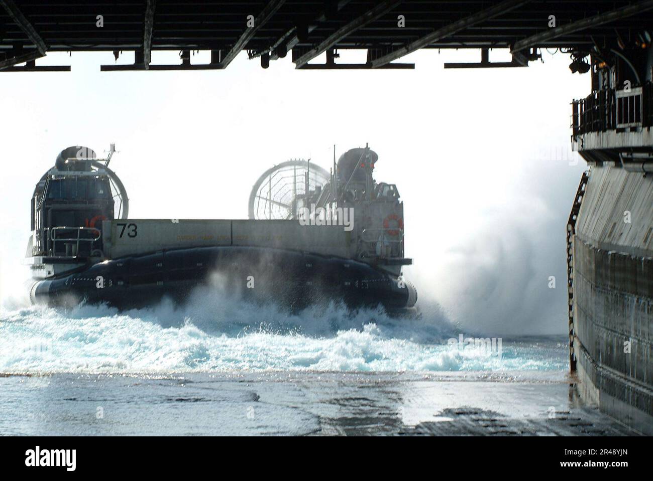 US Navy A Landing Craft, Air Cushion (LCAC) makes its way into the well ...