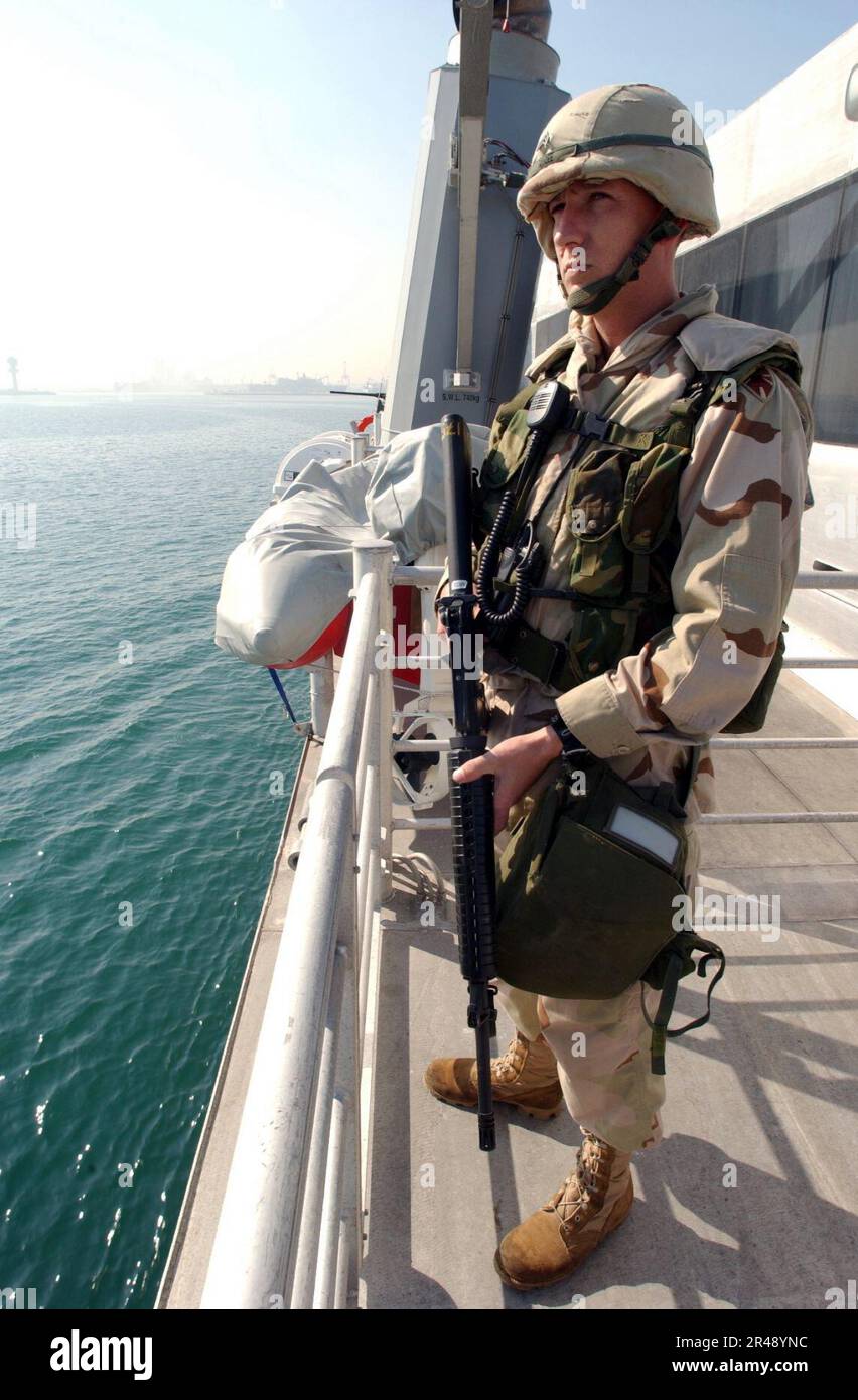 US Navy Staff Sgt. stands guard with an M-16 machine gun Stock Photo ...