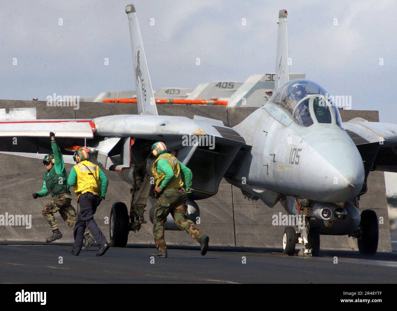 US Navy Flight deck personnel run to get behind the foul line Stock ...