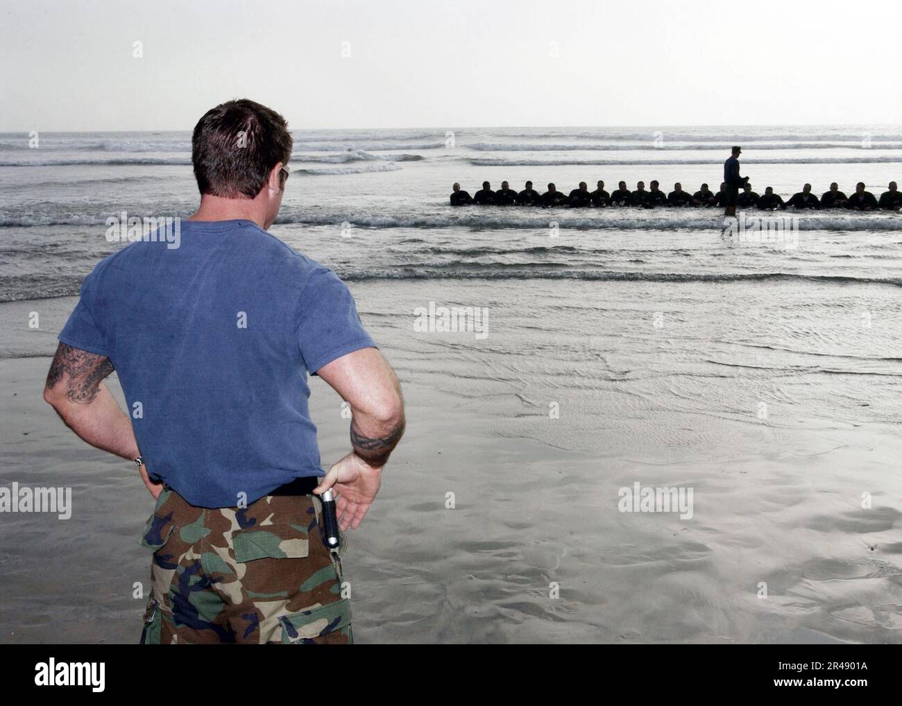 US Navy As an instructor monitors a training evolution, Basic ...