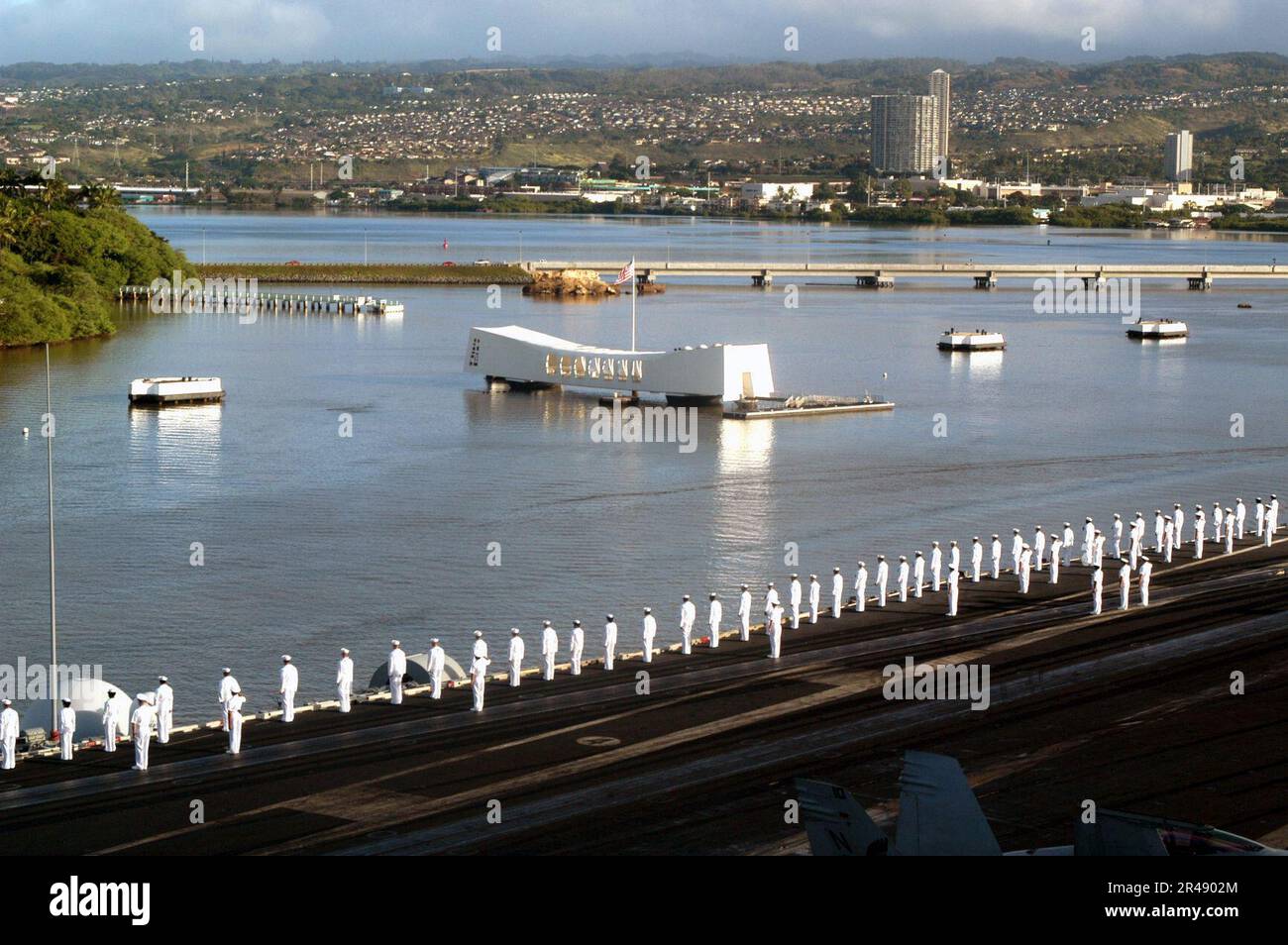 US Navy Sailors render honors to the Arizona Memorial as the aircraft ...