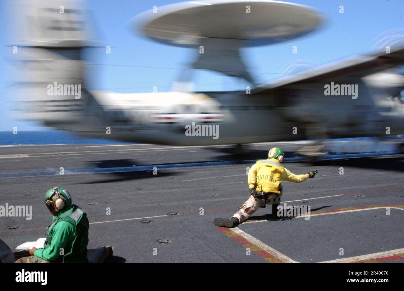 US Navy An Air Department shooter signals the launch of an E-2C Hawkeye ...