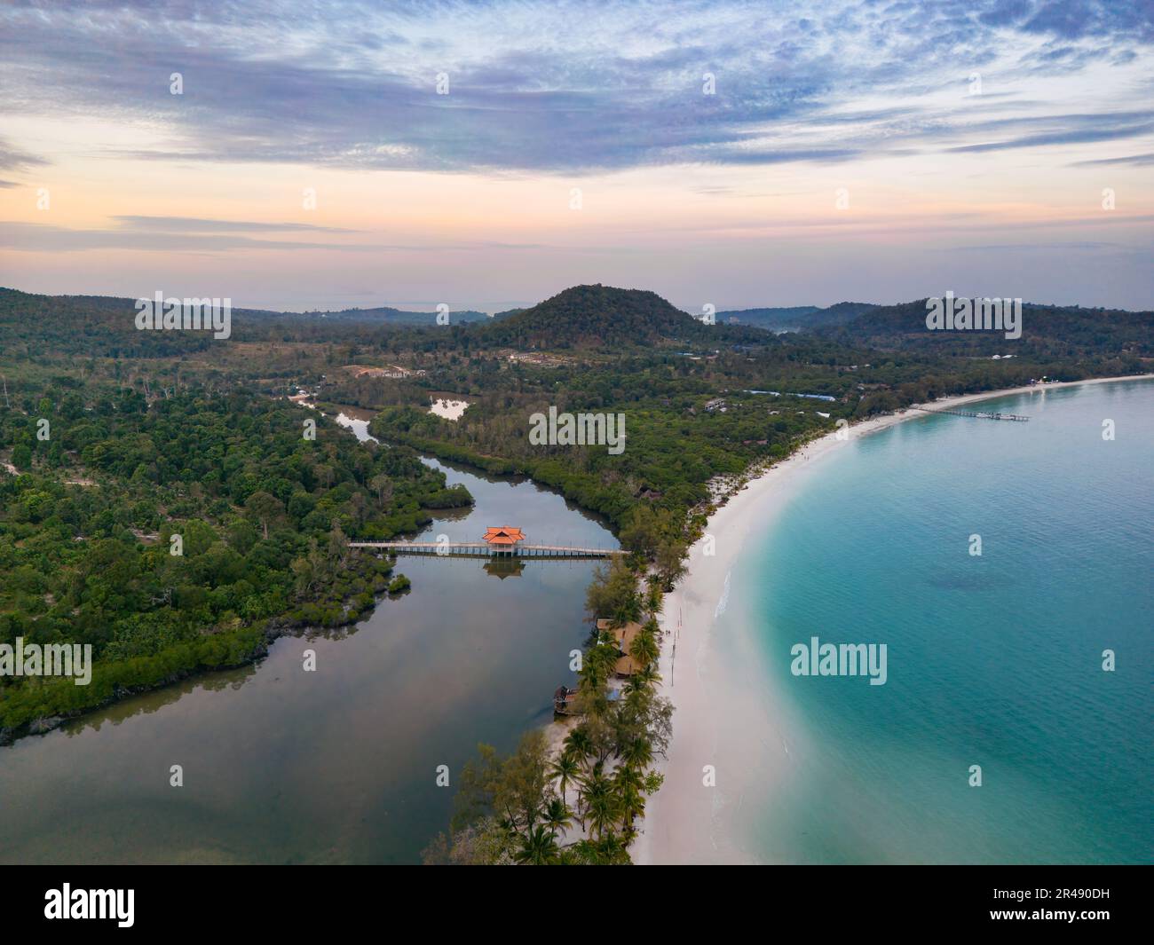 An aerial view of Koh Rong beach surrounded by dense trees during ...