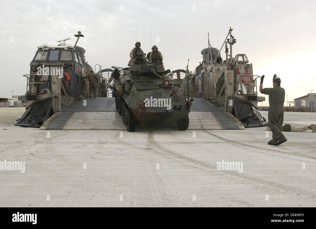 US Navy A Light Armored Vehicle (LAV) drives off of a Landing Craft Air ...
