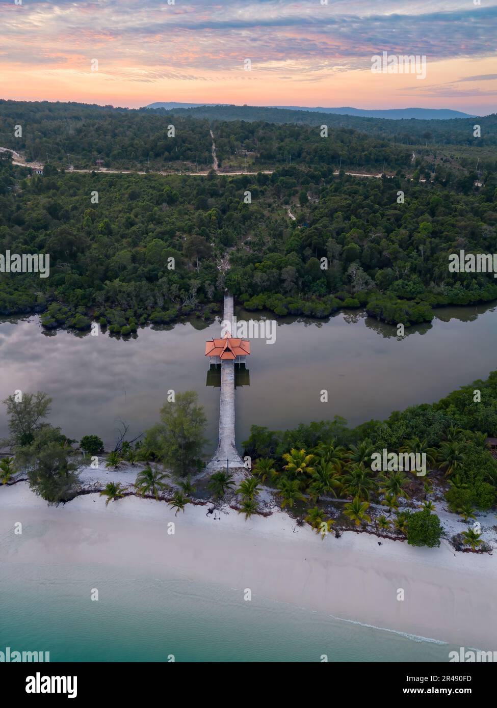 An aerial view of Koh Rong beach surrounded by dense trees during ...
