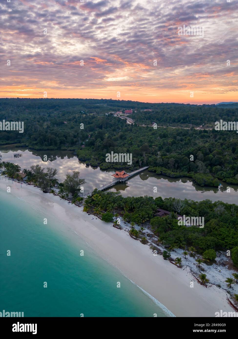 An aerial view of Koh Rong beach surrounded by dense trees during ...
