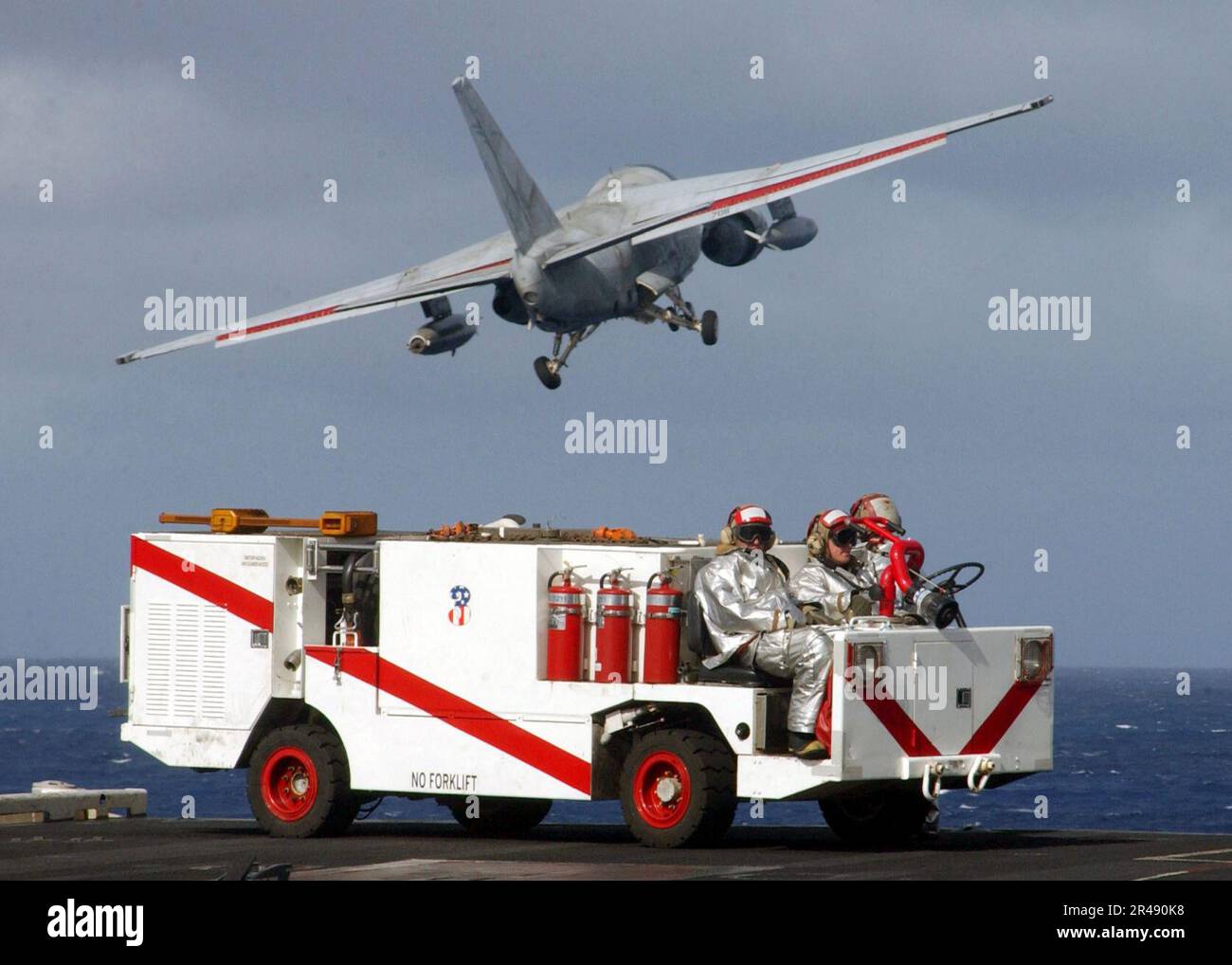 US Navy Crash and Salvage standby on the bow during flight operations ...