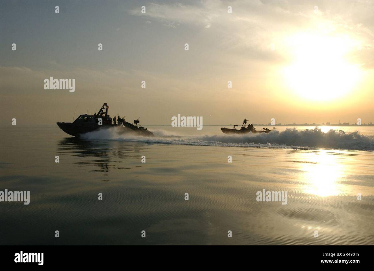 US Navy Naval Special Warfare combatant-craft crewmen operate a Rigid ...