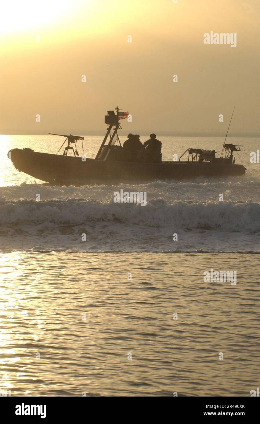 US Navy Naval Special Warfare combatant-craft crewmen operate a Rigid ...