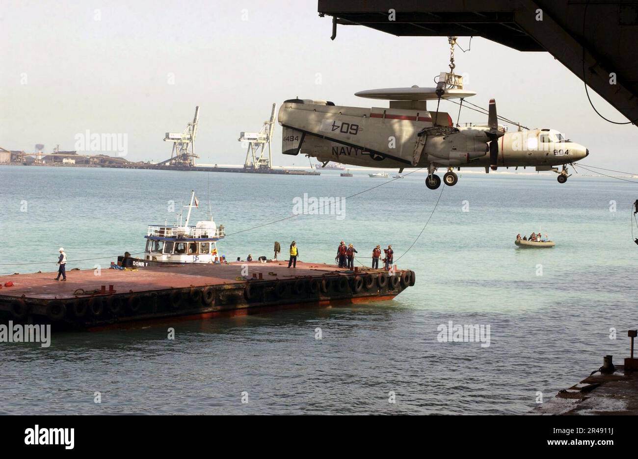 US Navy An E-2C ''Hawkeye'' is hoisted and lowered onto a barge in ...