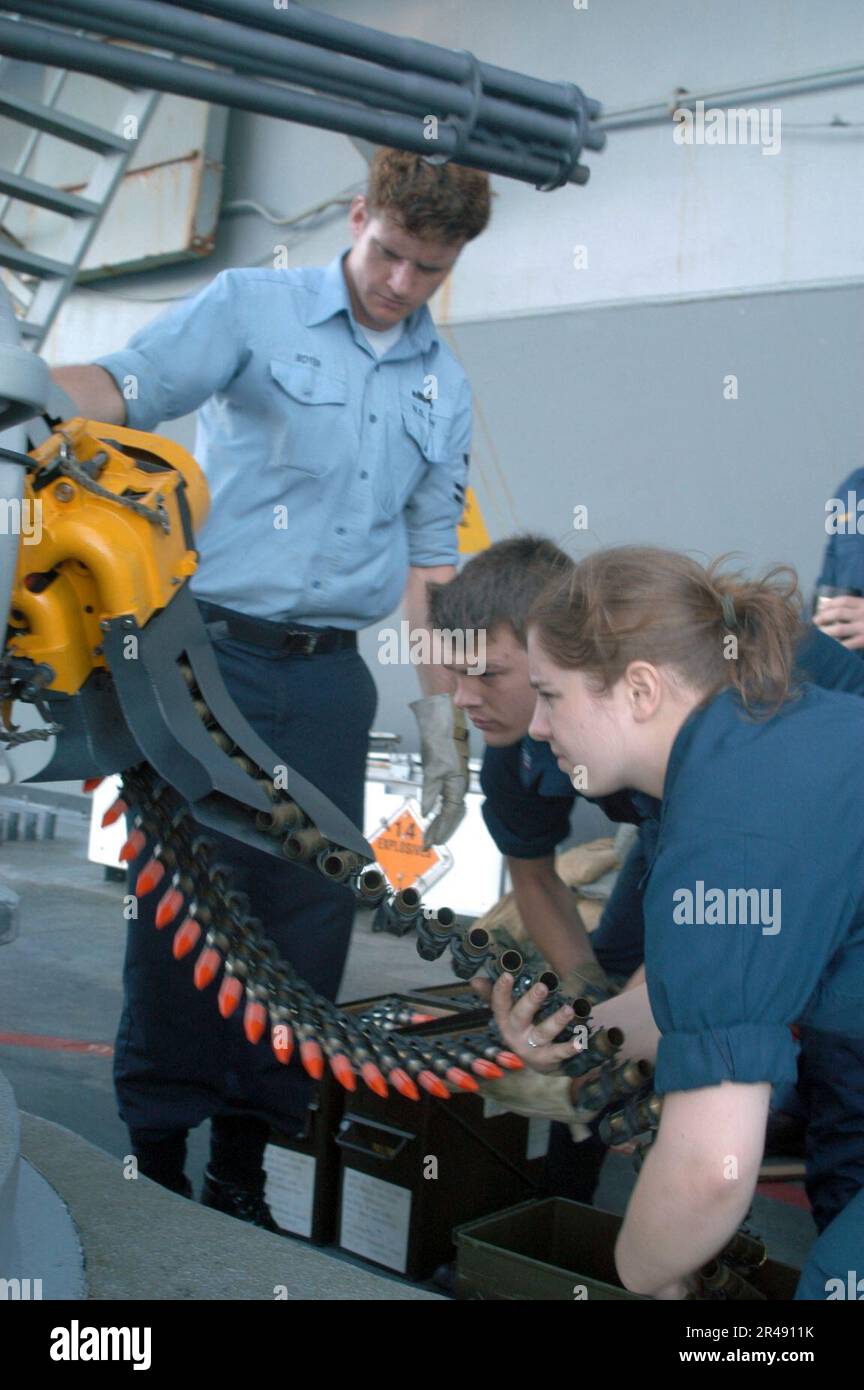 US Navy Fire Controlmen perform a maintenance inspection on a Close-In ...