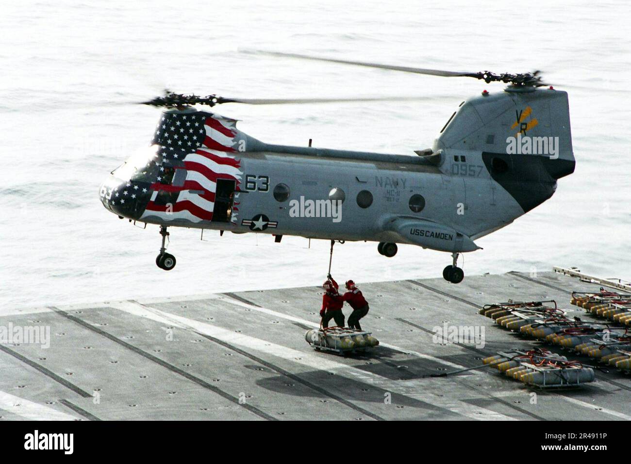 US Navy Sailors attach a cargo hook to a CH-46 ''Sea Knight ...