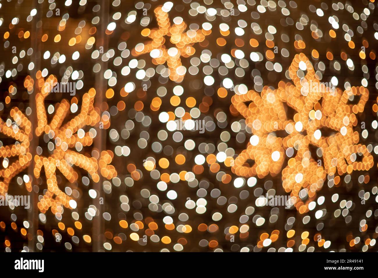 A macro image of a single snowflake illuminated against a white ...