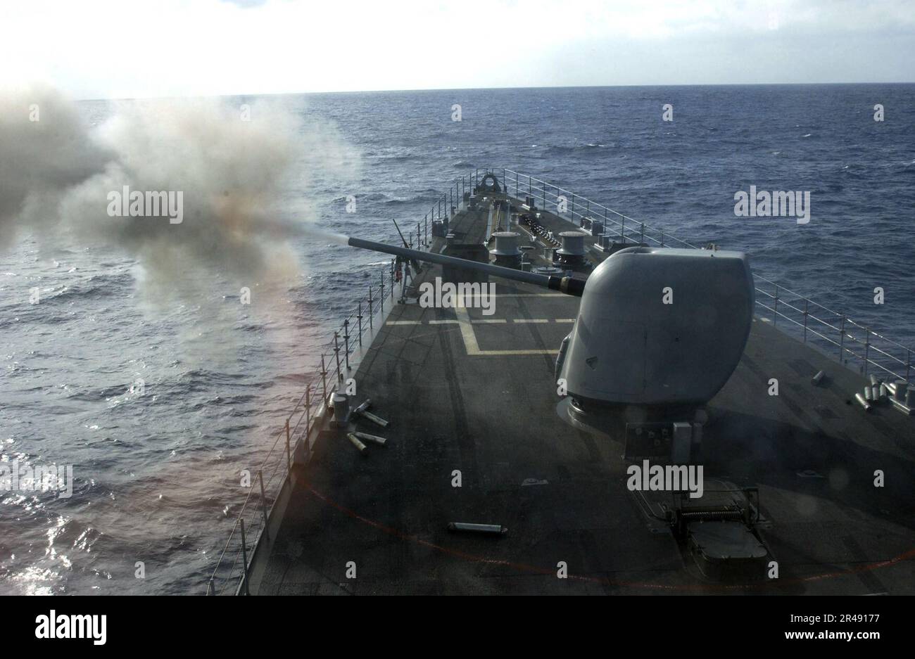 US Navy A 51-caliber MK 45 gun fires a round during a surface-to ...