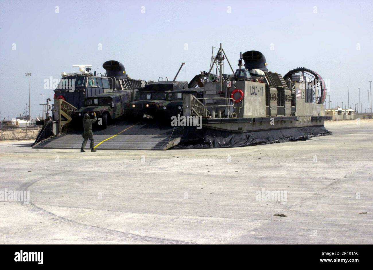 US Navy A member of Assault Craft Unit Five (ACU-5) directs U.S Marine ...