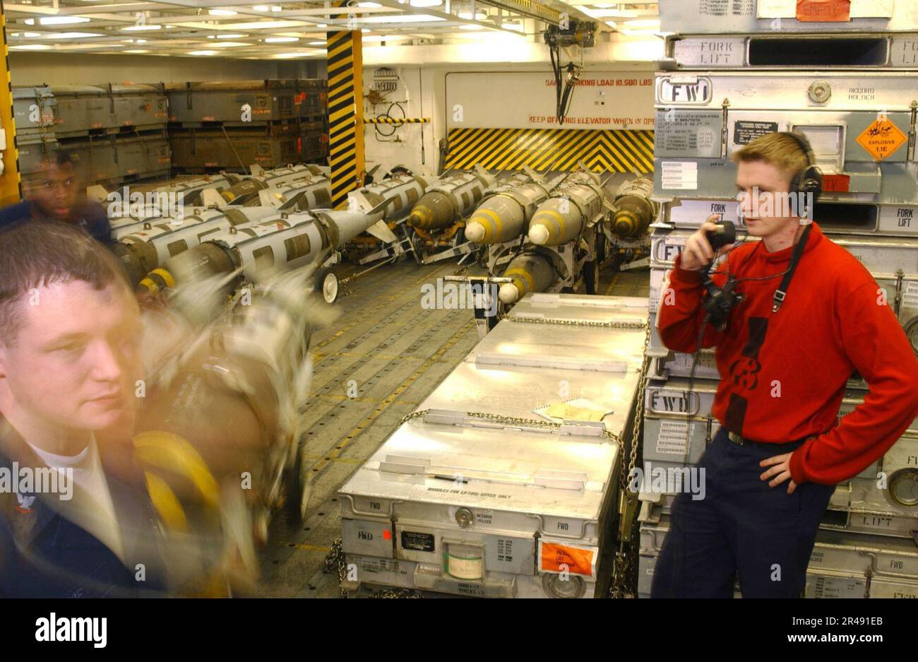 US Navy Weapons handlers in ship's magazine aboard USS Harry S. Truman ...