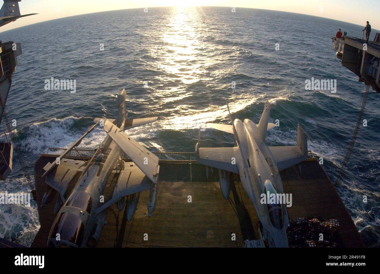 US Navy An EA-6B and an F-A-18C are raised to the flight deck on one of ...
