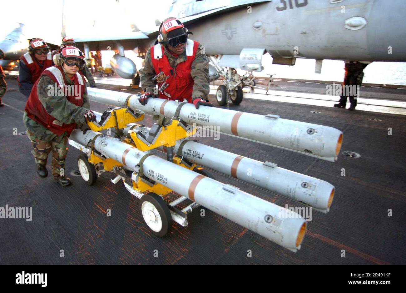 US Navy Sailors move munitions Stock Photo - Alamy