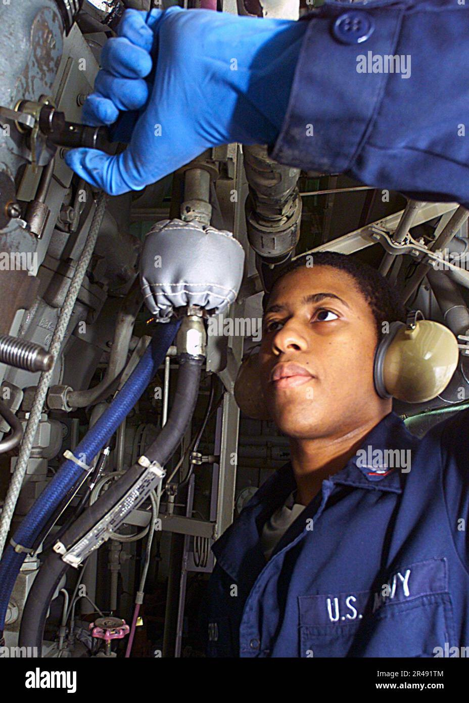 US Navy Engineman performs checks on a Diesel Rack Alignment aboard the ...