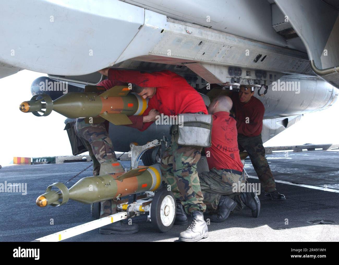 US Navy Aviation Ordnancemen install a GBU-31 Joint Direct Attack ...