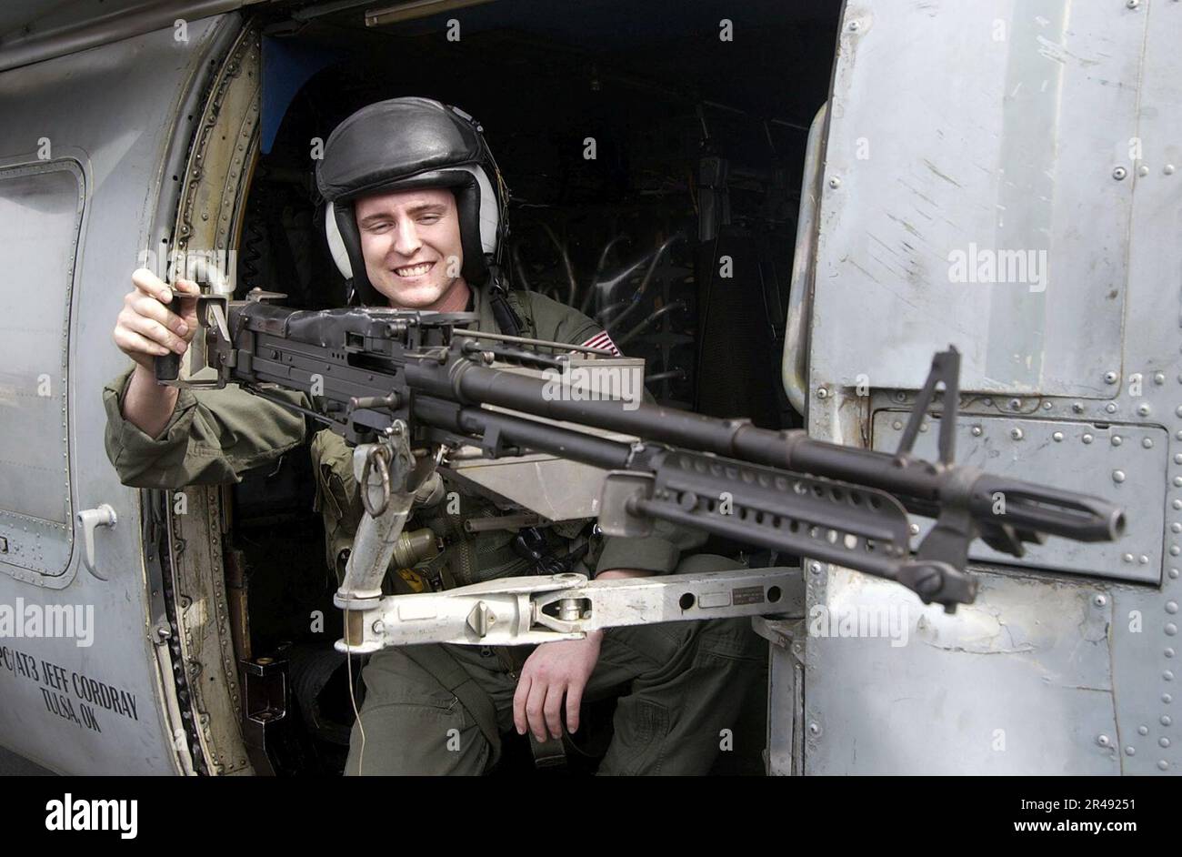 US Navy Aviation Warfare Systems Operator Jon Leney checks a M-60 ...