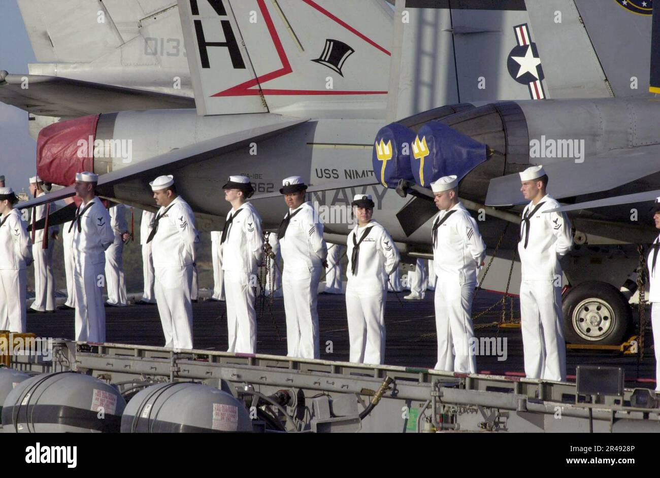 US Navy Crewmembers aboard the aircraft carrier USS Nimitz (CVN 68) man ...
