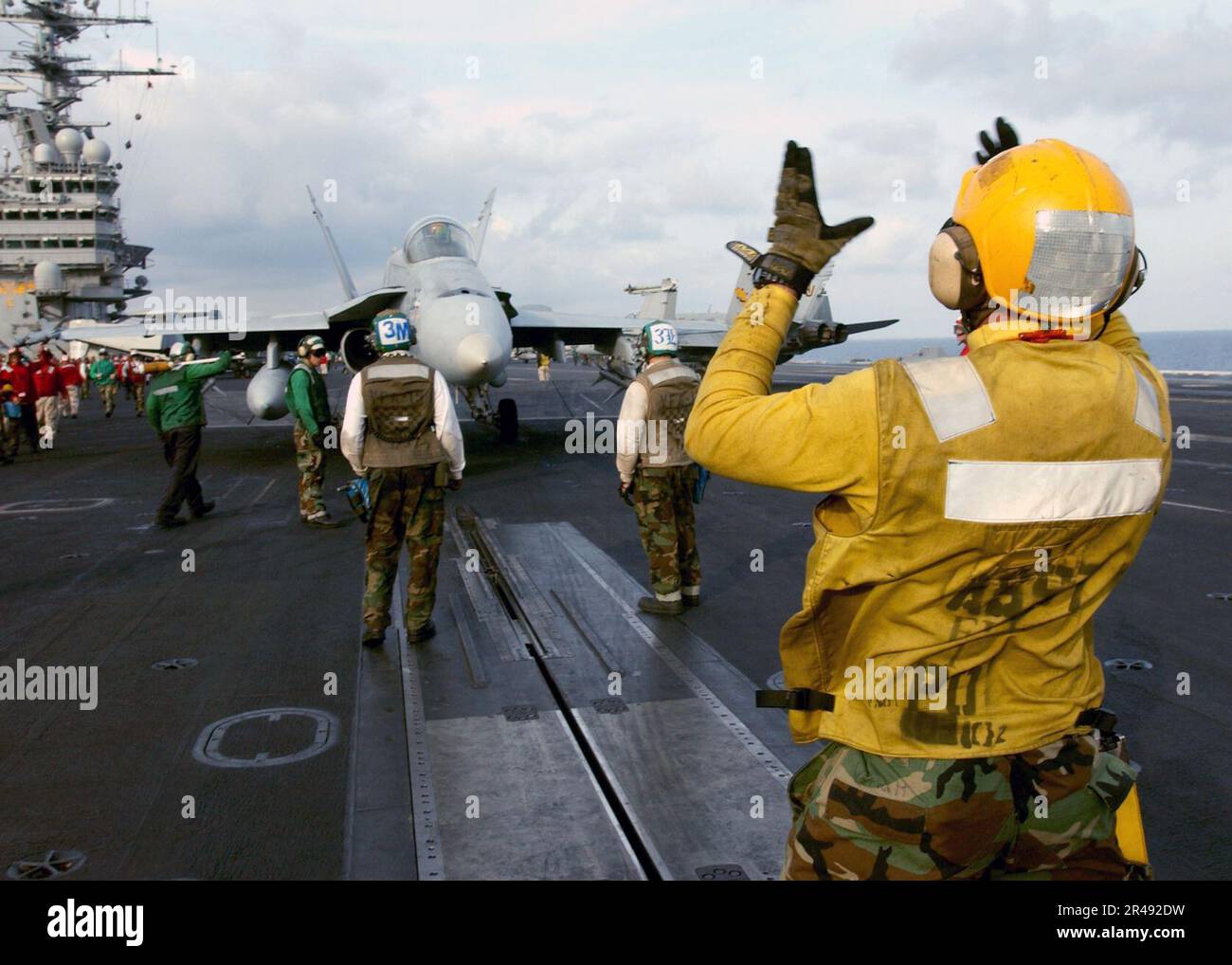 US Navy An Aviation Boatswain's Mate guides an F-A-18C Hornet from the ...