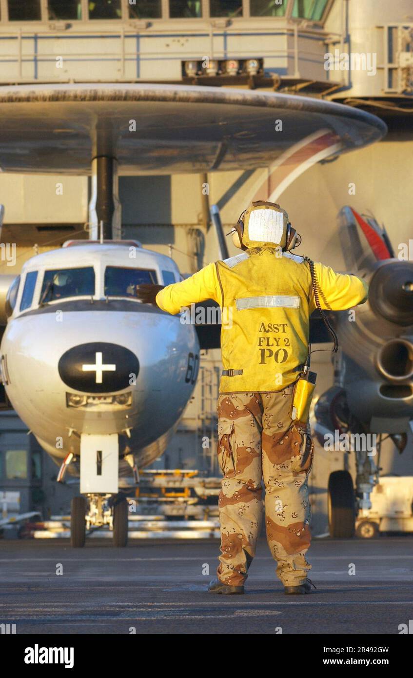US Navy An aircraft director signals to an E-2C Hawkeye to move forward ...