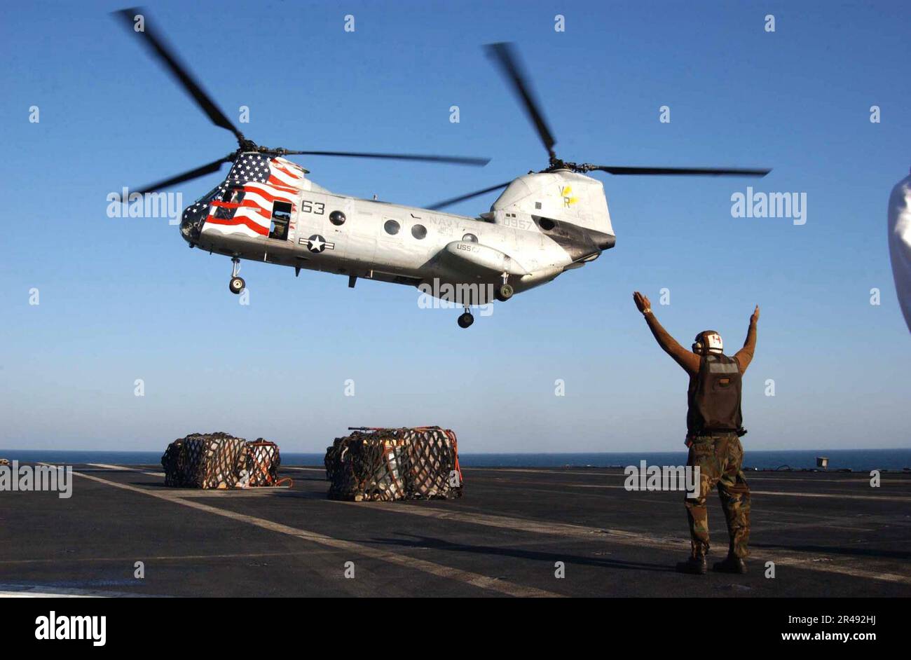 US Navy A Sailor on the flight deck aboard USS Abraham Lincoln (CVN 72) directs a CH-46 Sea ...