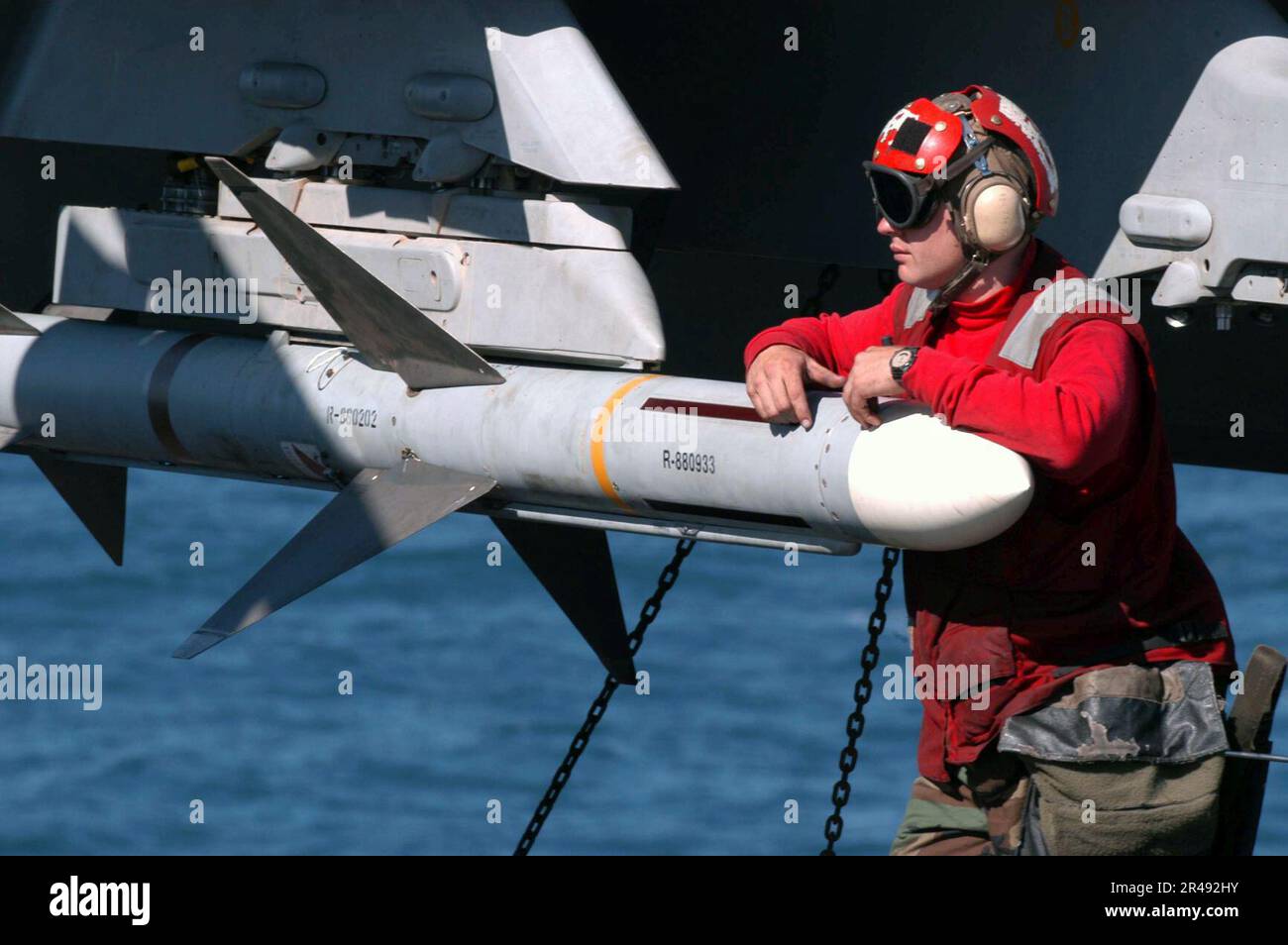 US Navy An Aviation Ordnanceman takes a moment to rest on an AIM -7 ...