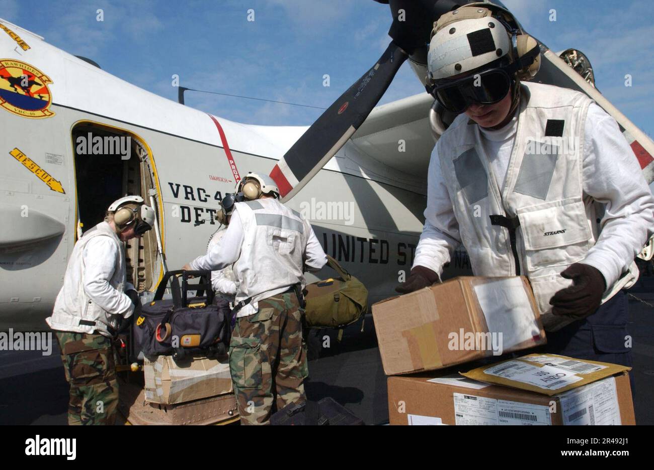 US Navy Air Transfer Office personnel load gear onto a C-2A Greyhound ...