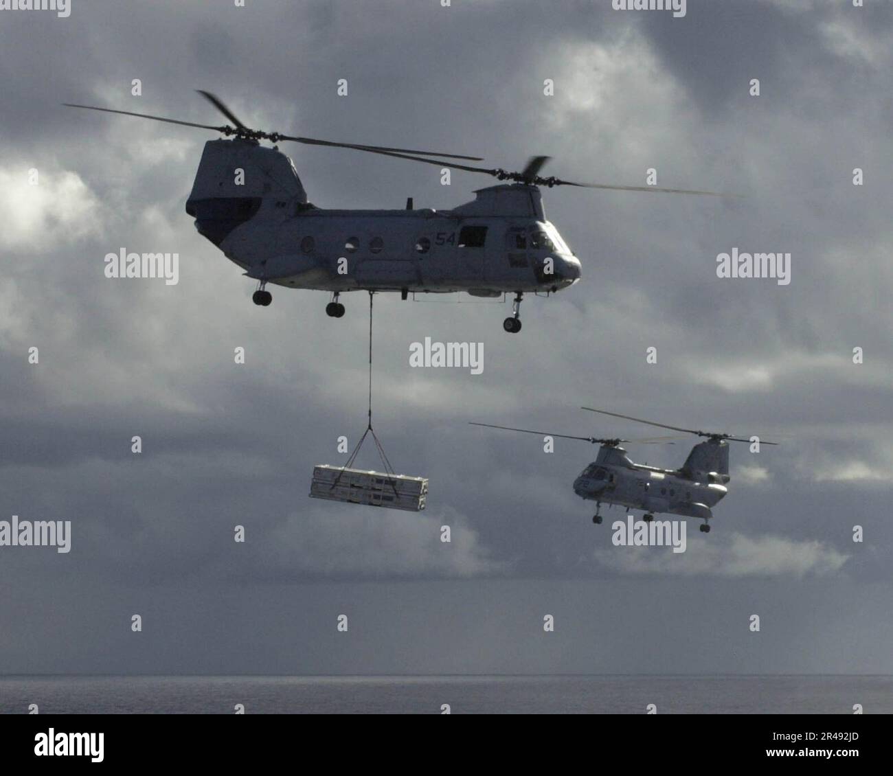 US Navy Two CH-46 Sea Knight helicopters transfer ordnance Stock Photo ...