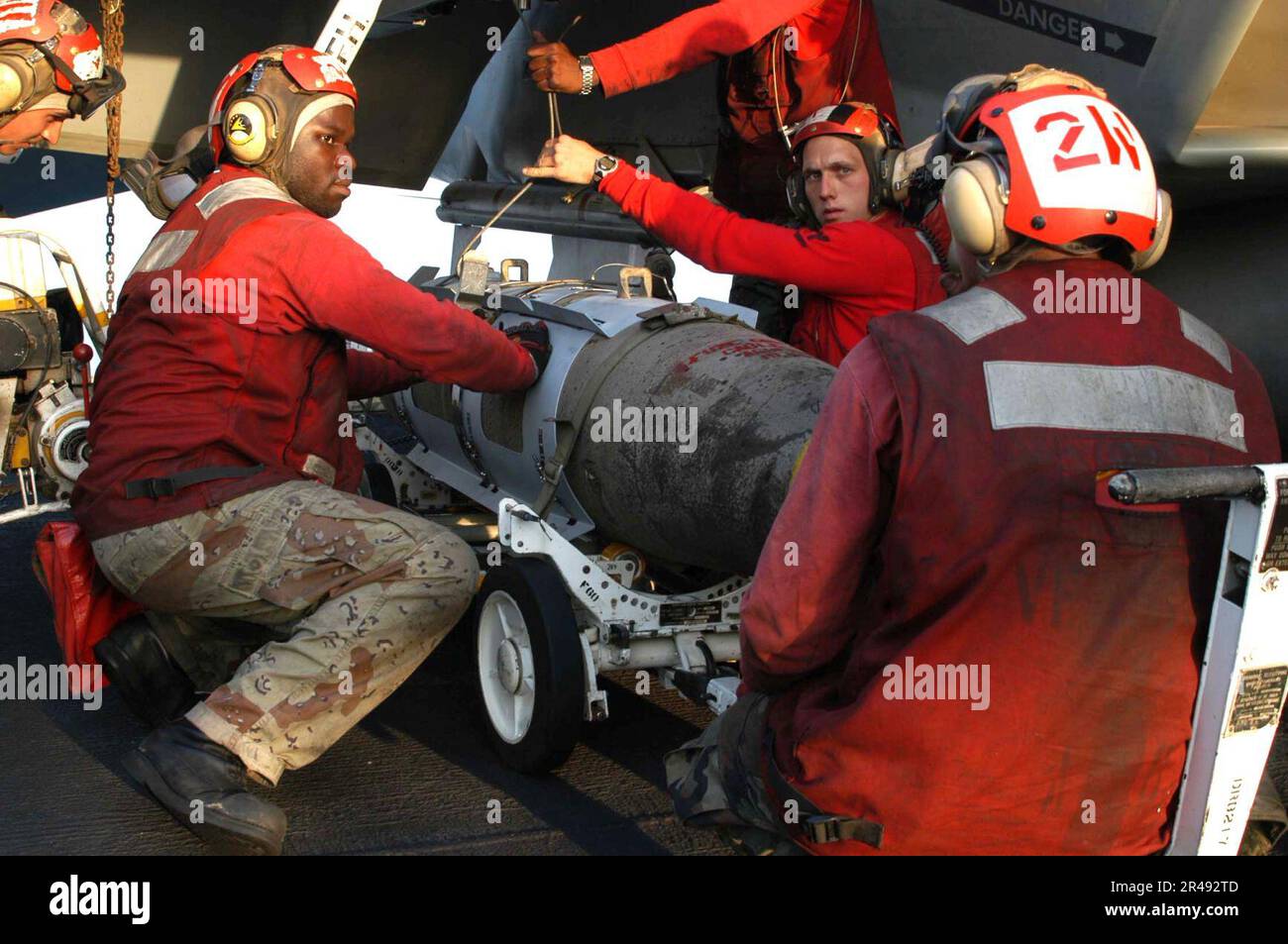 US Navy Aviation Ordnancemen load a Joint Direct Attack Munitions (JDAM ...