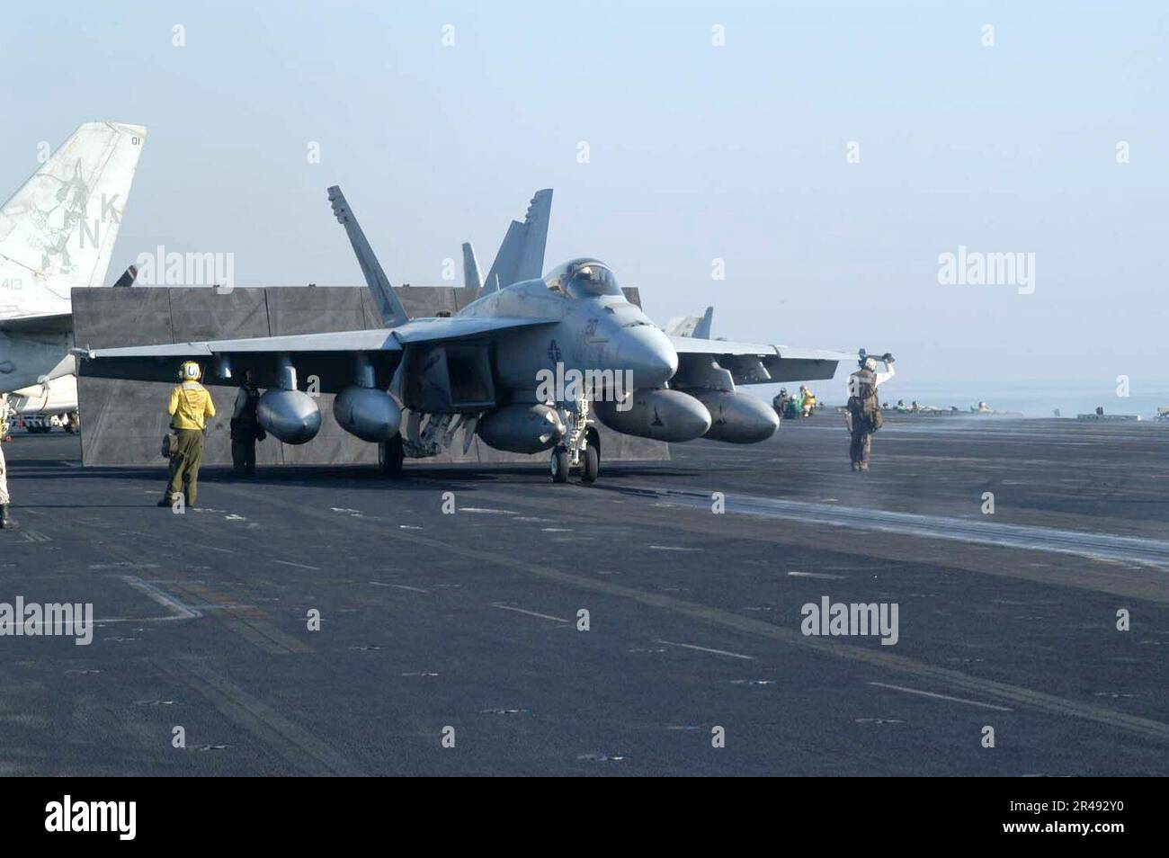 US Navy The flight deck crew performs last minute checks as an F-A-18E ...