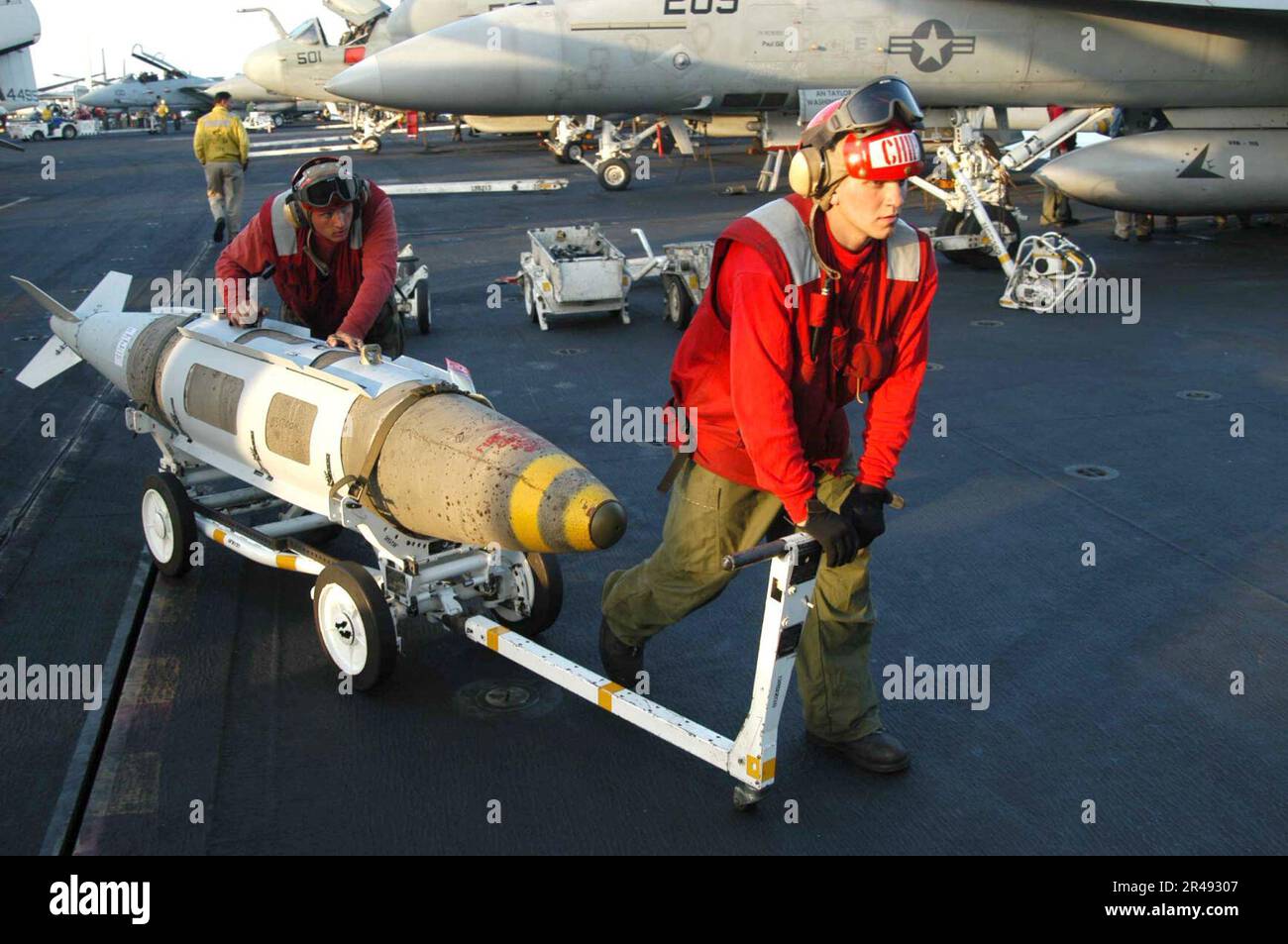 US Navy Aviation Ordnancemen move a Joint Direct Attack Munitions (JDAM ...